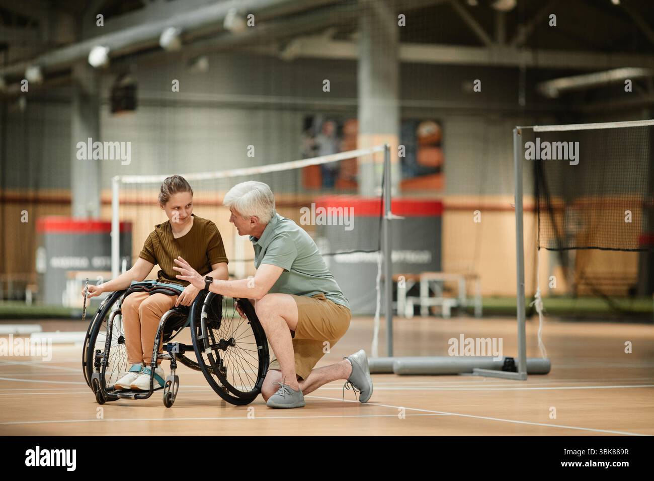 Coach Training Athlete with Disability at Sports Court Stock Photo - Alamy