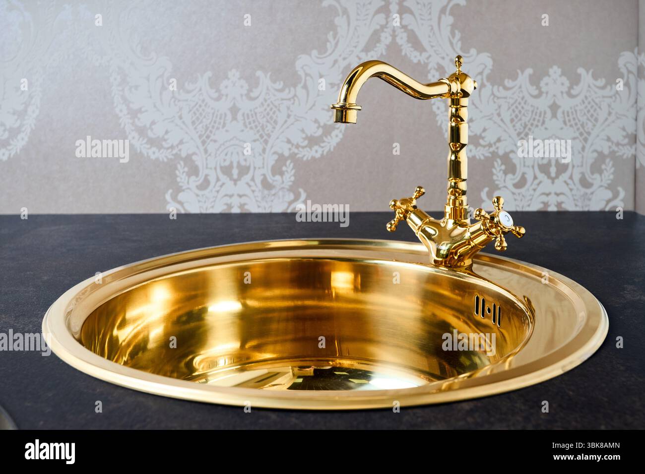 Kitchen luxurious interior with golden brass round sink basin and ...