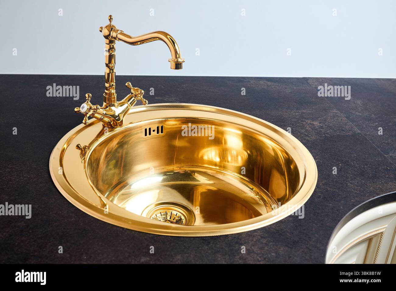 Kitchen luxurious interior with golden brass round sink basin and ...