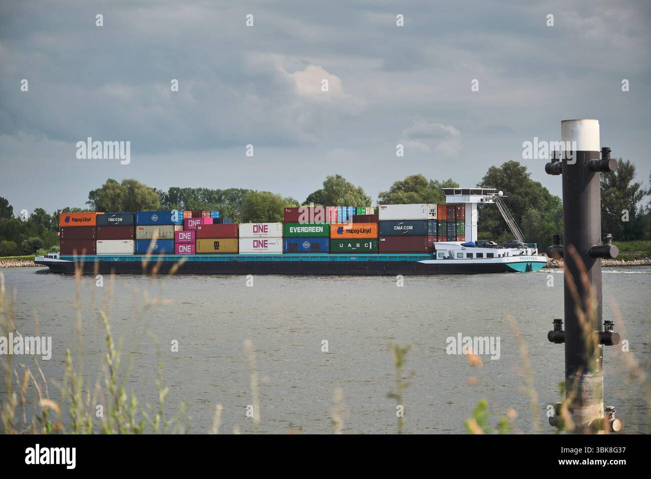 June 2, 2025 - Tolkamer-Netherlands: Inland container ship sails ...