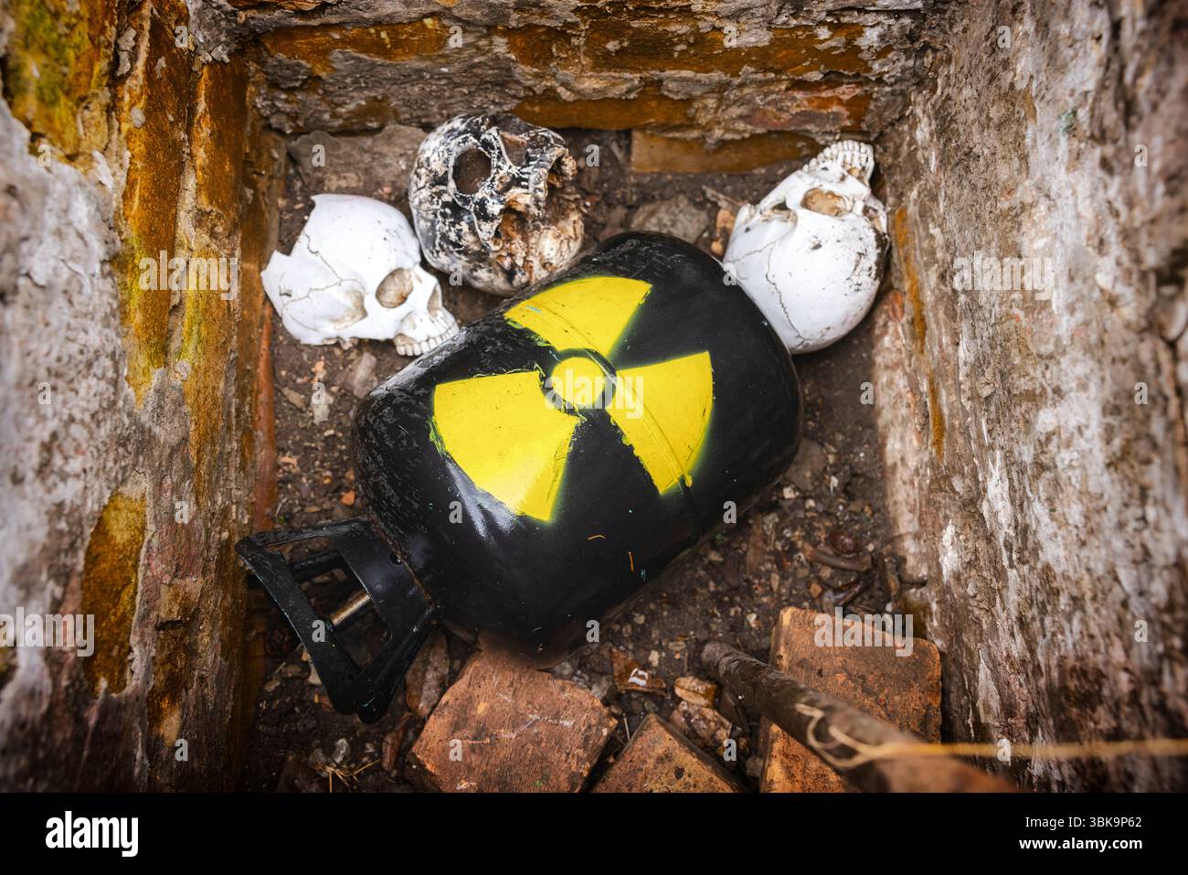 Nuclear waste between skulls close up photo Stock Photo - Alamy