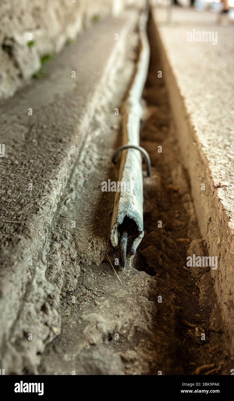 Lead pipe used in ancient civilizations in the ground closeup Stock ...