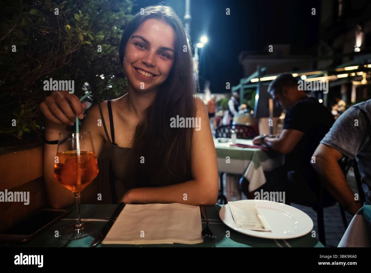 Woman sitting at table hi-res stock photography and images - Alamy