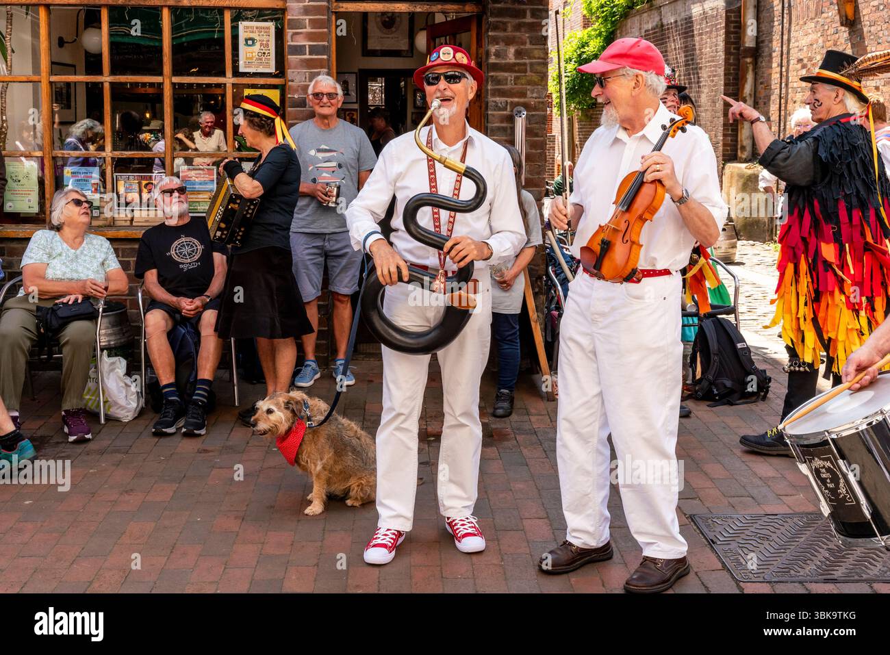 Musicians from The Knots of May Morris Side wait to perform in the town ...
