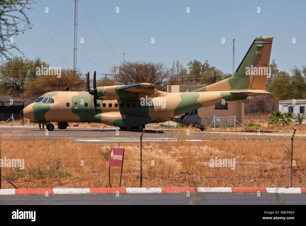 military airplane with propellers unloading military equipment at the ...