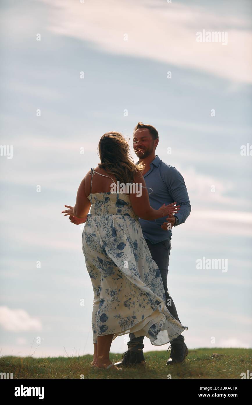 Romantic couple dancing outdoors on mountain field Stock Photo - Alamy