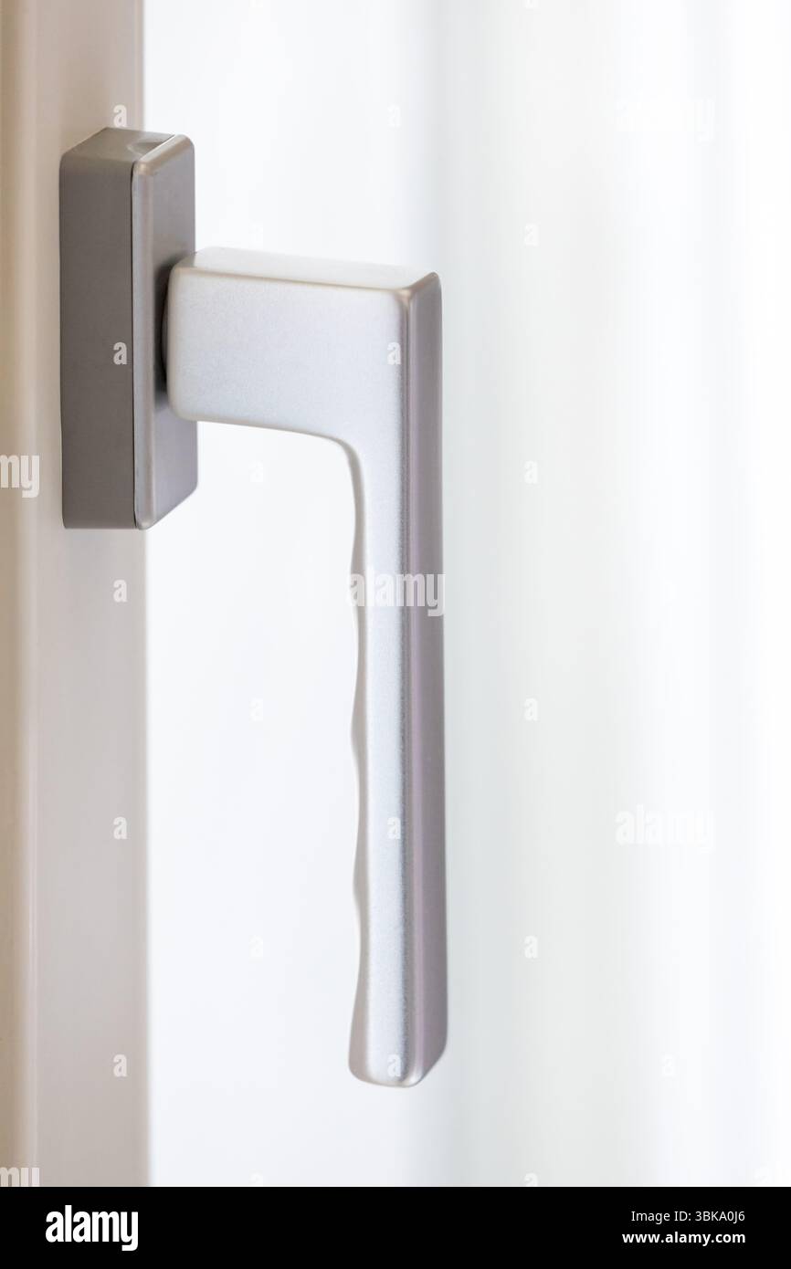 Silver window handle attached to a white frame hi-res stock photography ...
