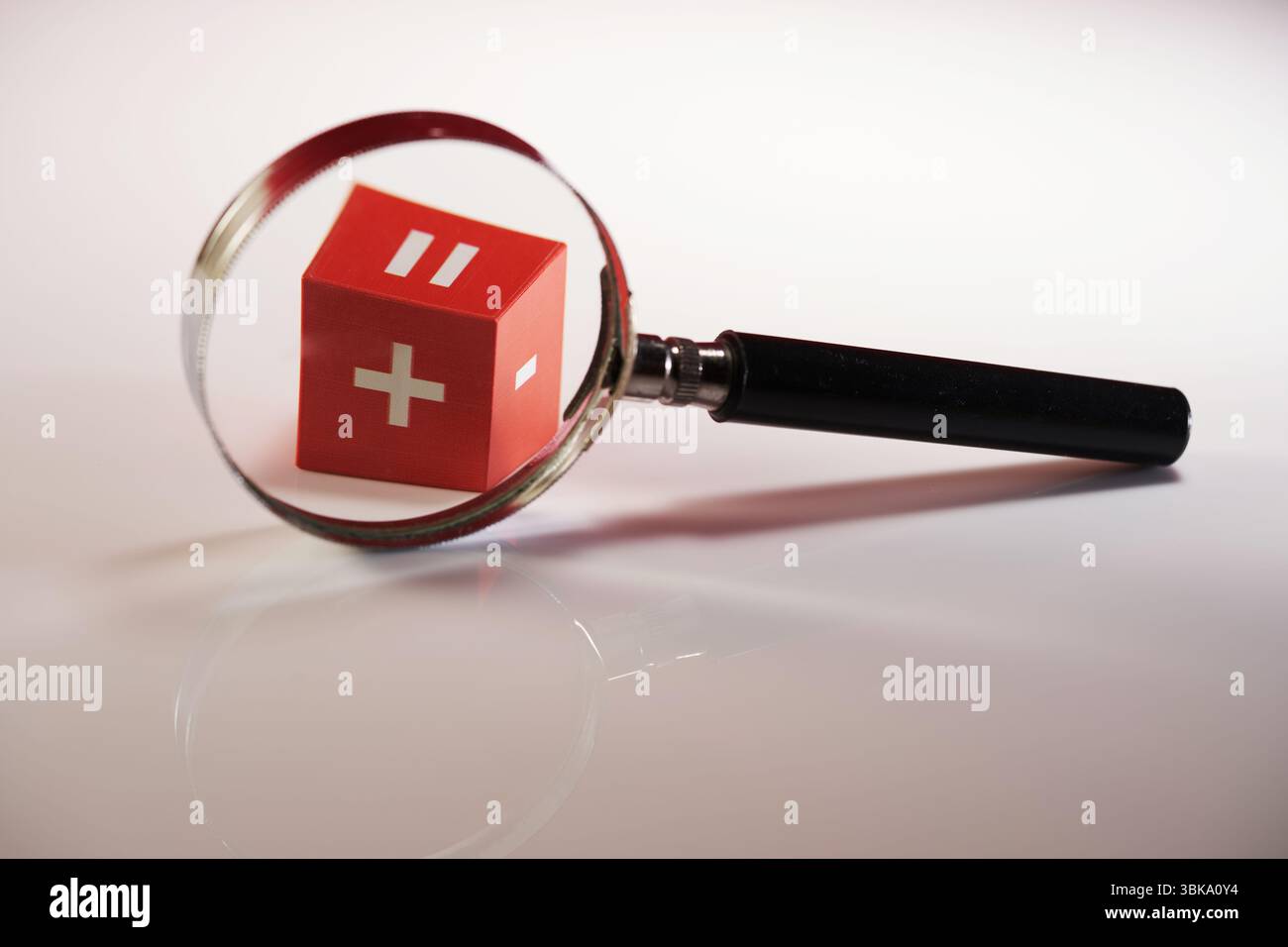 magnifying glass on toy block with mathematic sign isolated white ...