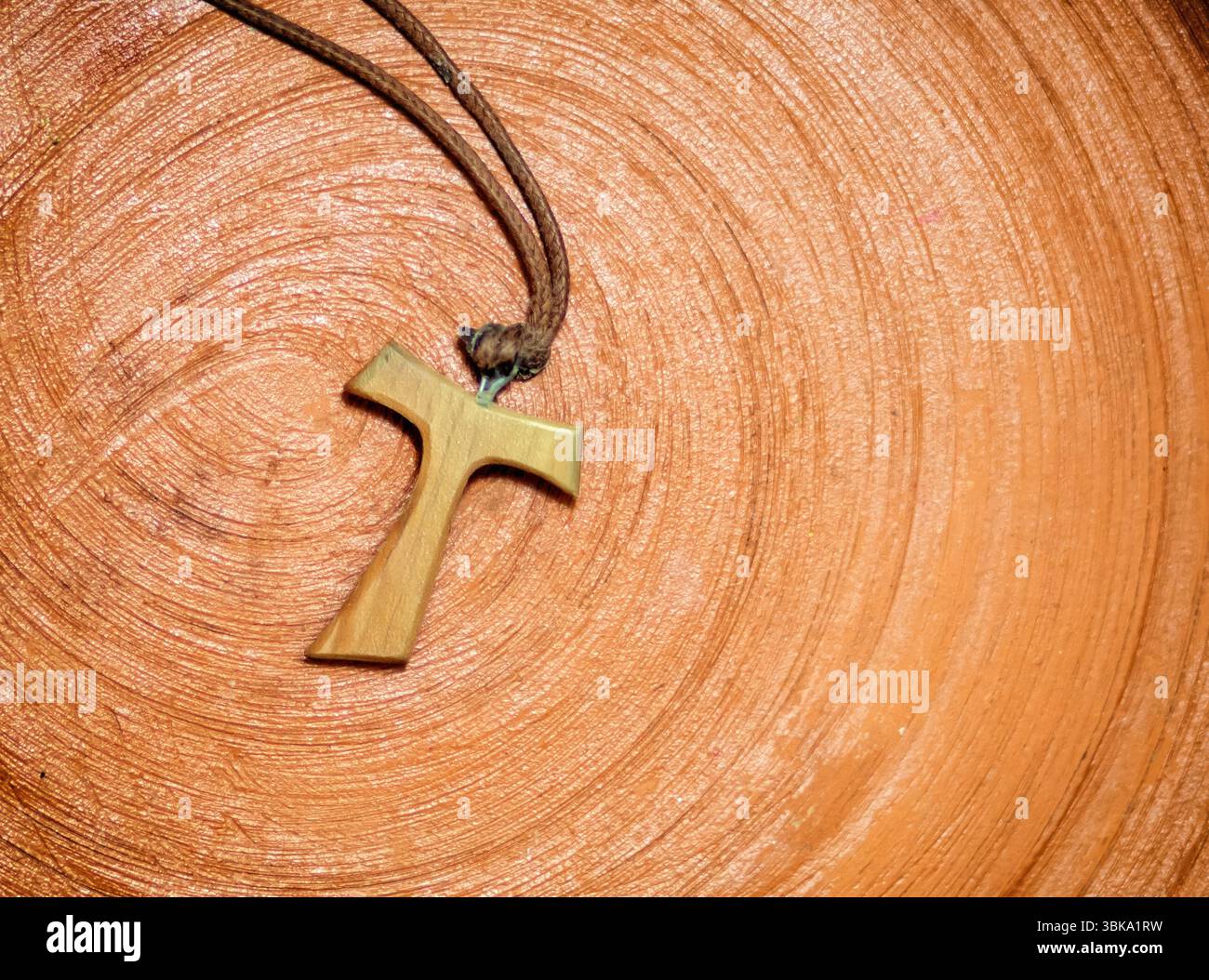 Wooden Tau Cross Pendant With Brown Cord Resting On A Terracotta ...