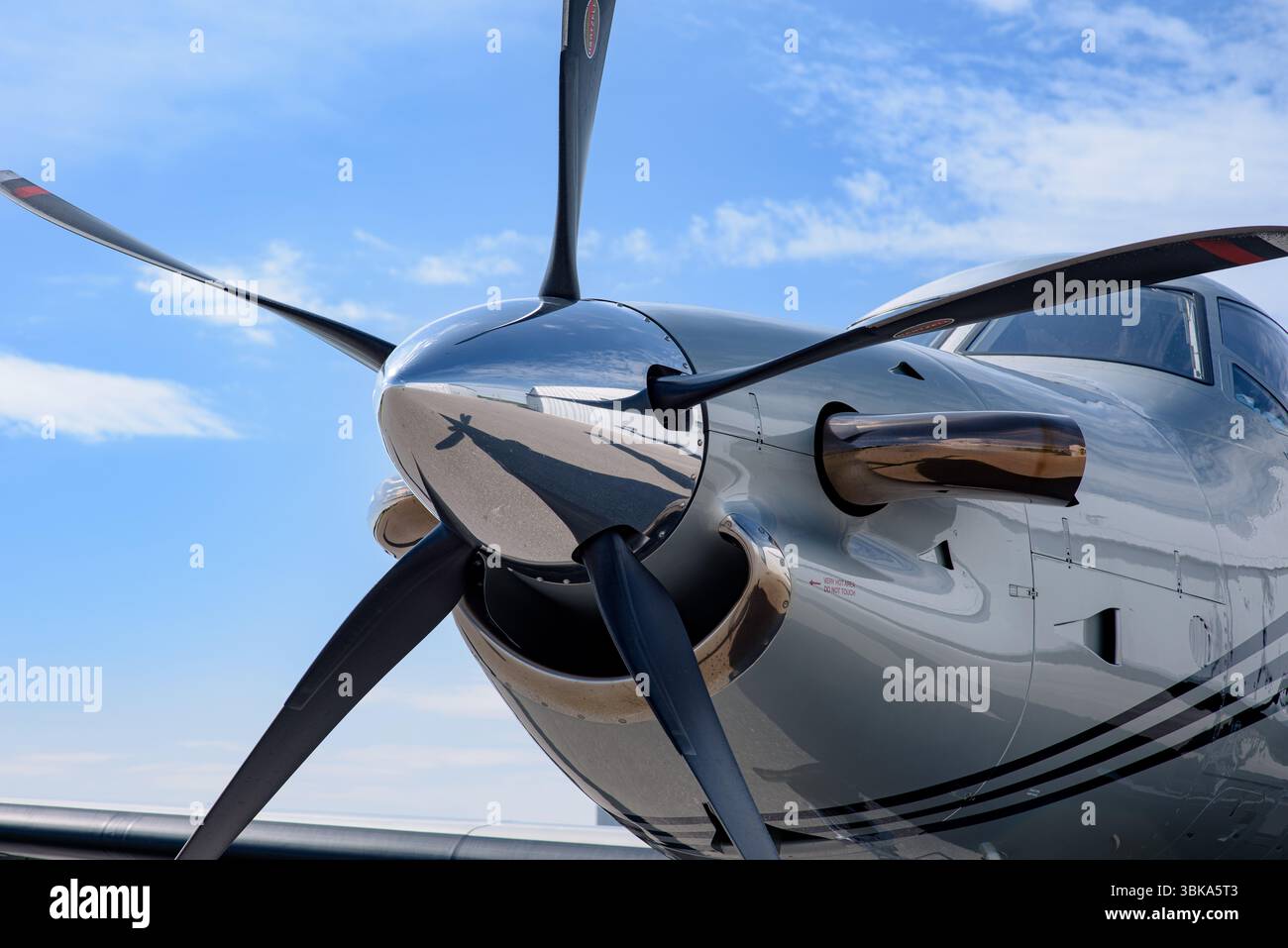 Angled close-up of a turboprop aircraft propeller and nose with ...