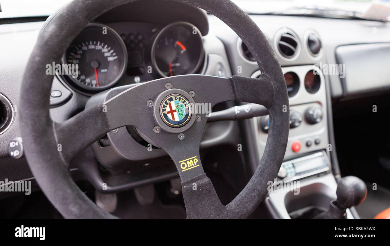 custom OMP racing steering wheel and classic analogue dashboard within an Alfa Romeo interior ...