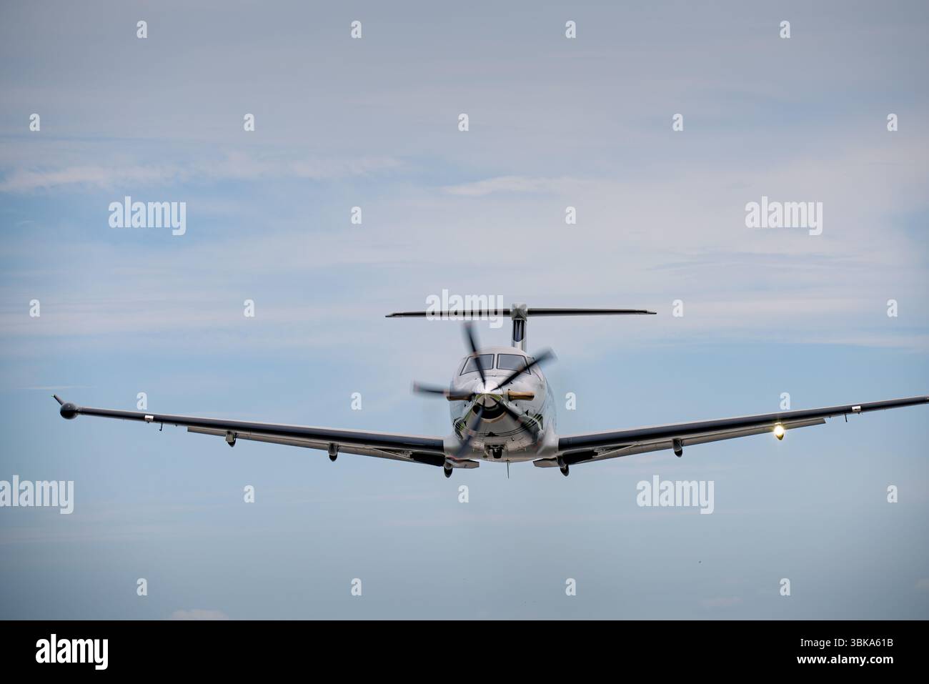 Climb-out shot of a Pilatus PC-12 viewed from the front, showing ...