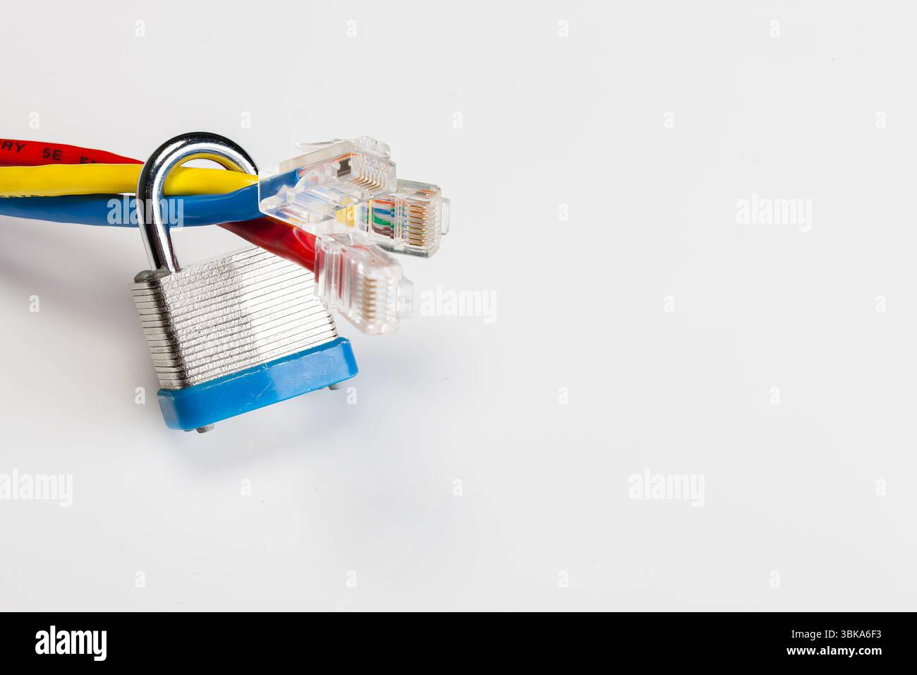 An Ethernet cable coiled with a metal padlock around its connector lies ...