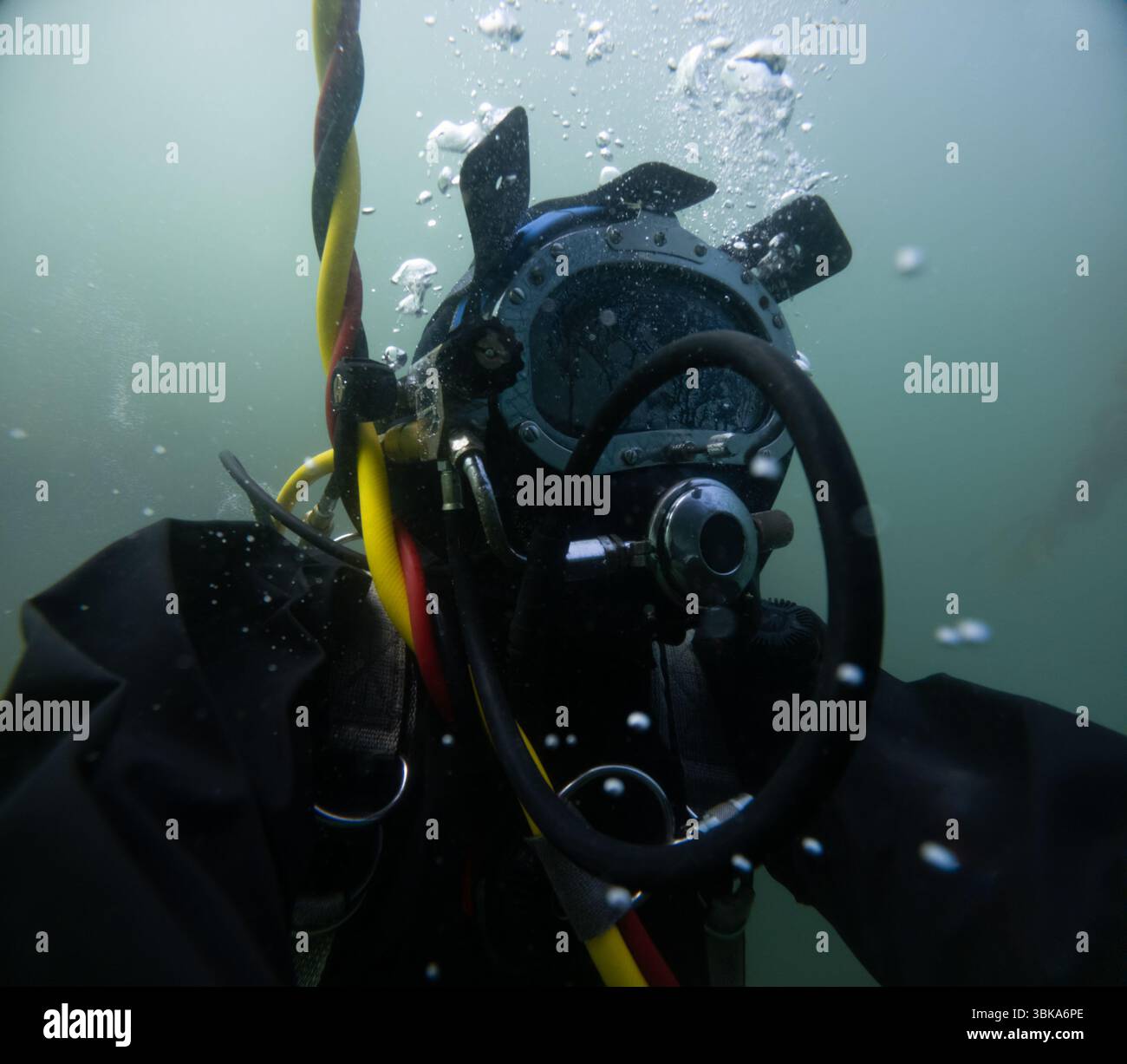 Commercial diver in helmet working underwater closeup Stock Photo - Alamy