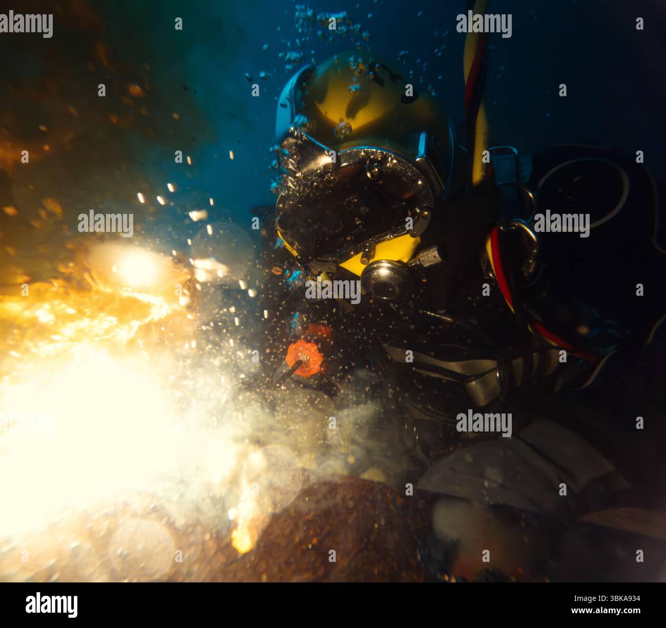 Commercial diver welding underwater at construction site Stock Photo ...