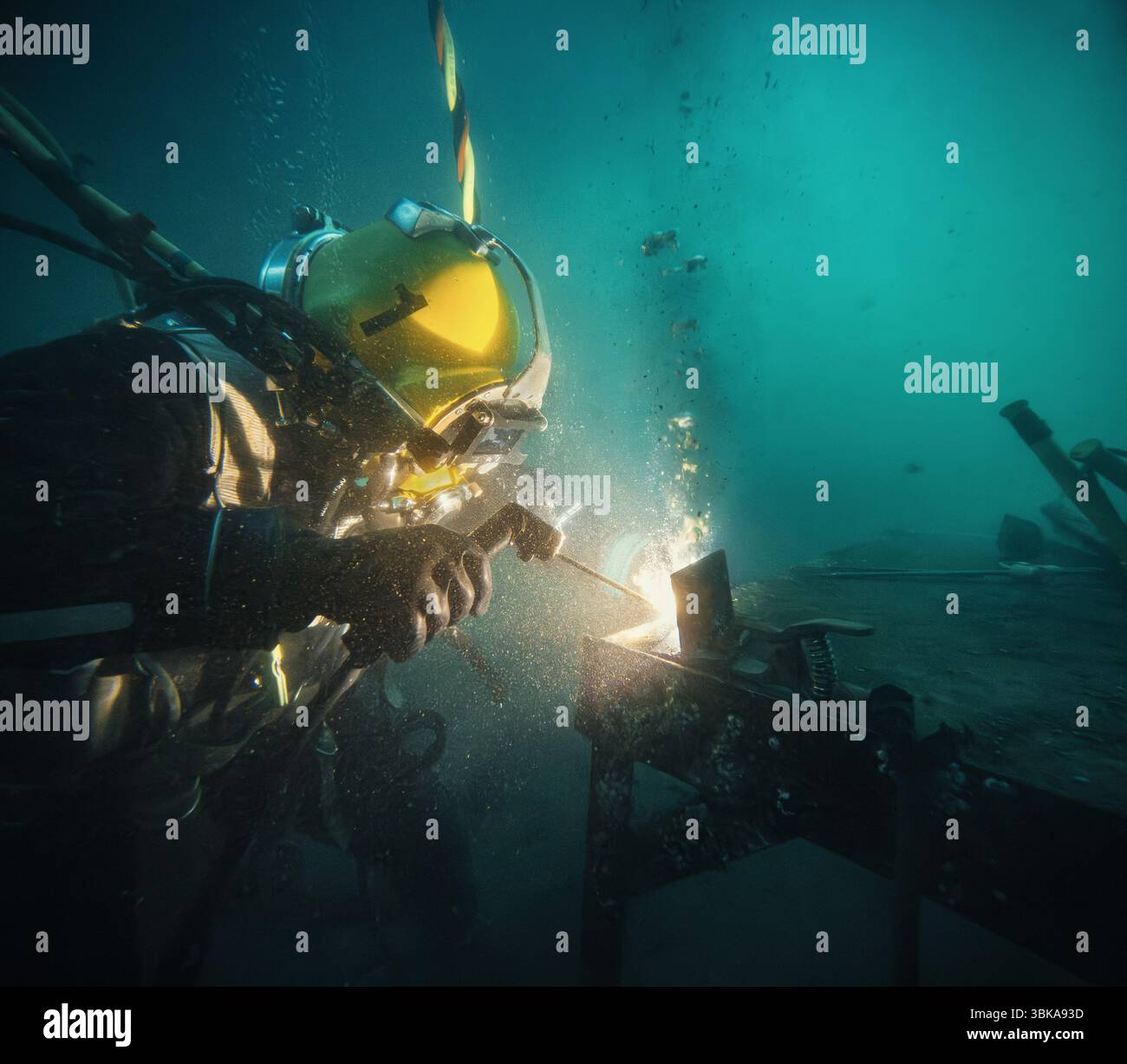 Commercial diver welding underwater at construction site Stock Photo ...