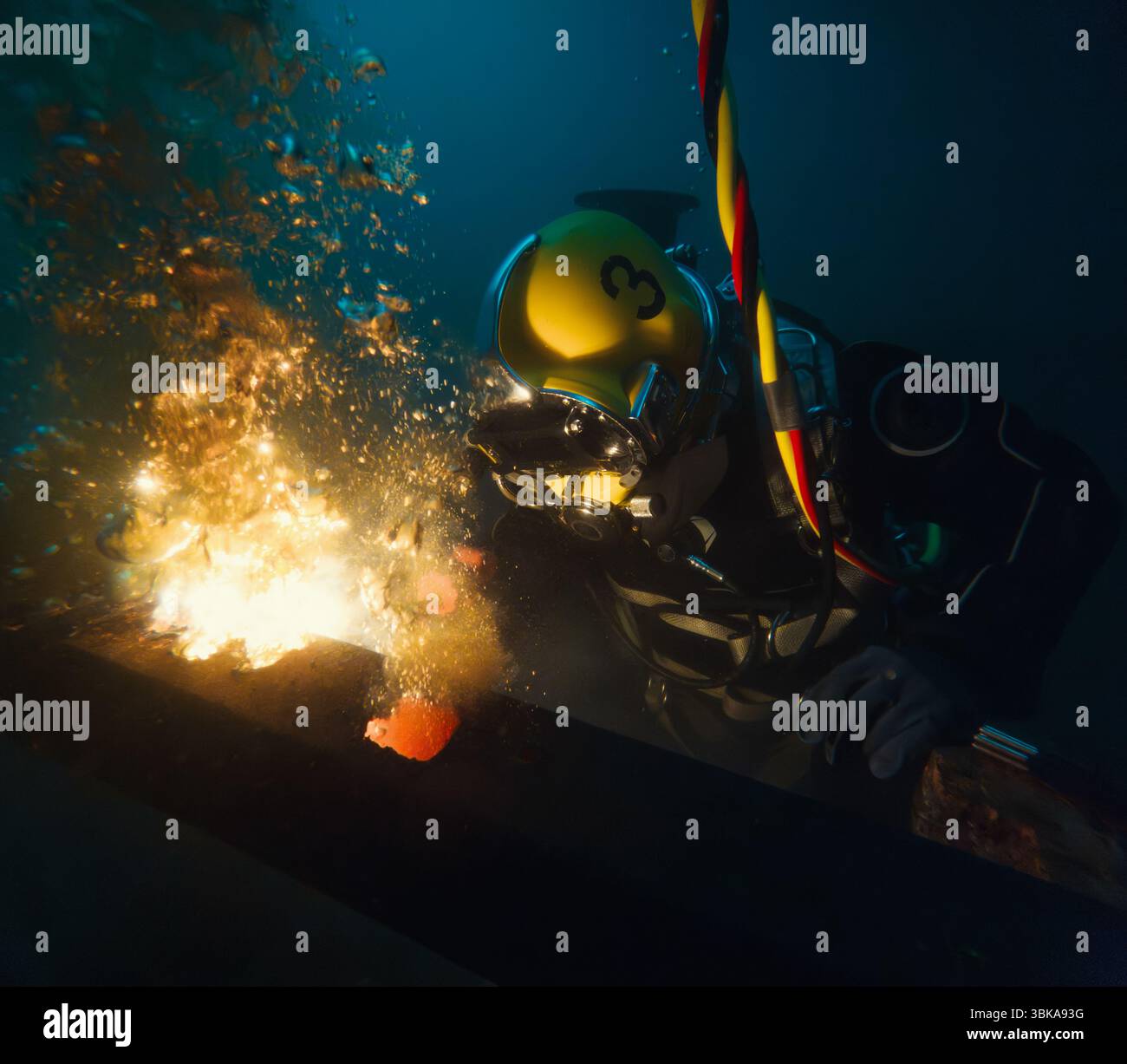 Commercial diver welding underwater at construction site Stock Photo ...