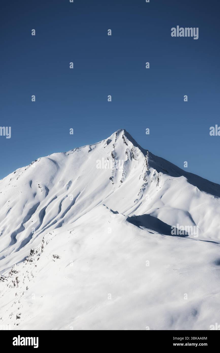 Mountain peak covered with snow in Alps background Stock Photo - Alamy
