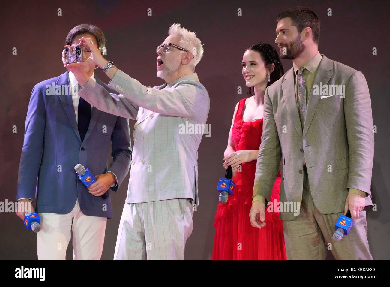Superman director James Gunn, second from left, takes a video with ...