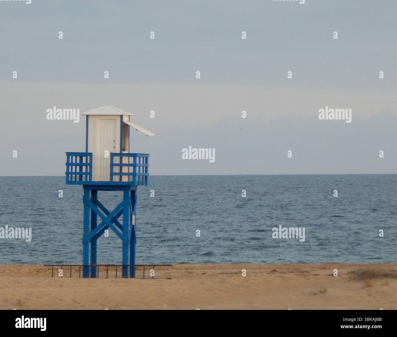 The lifeguard's blue wooden chair on the sand of a lonely beach Stock ...