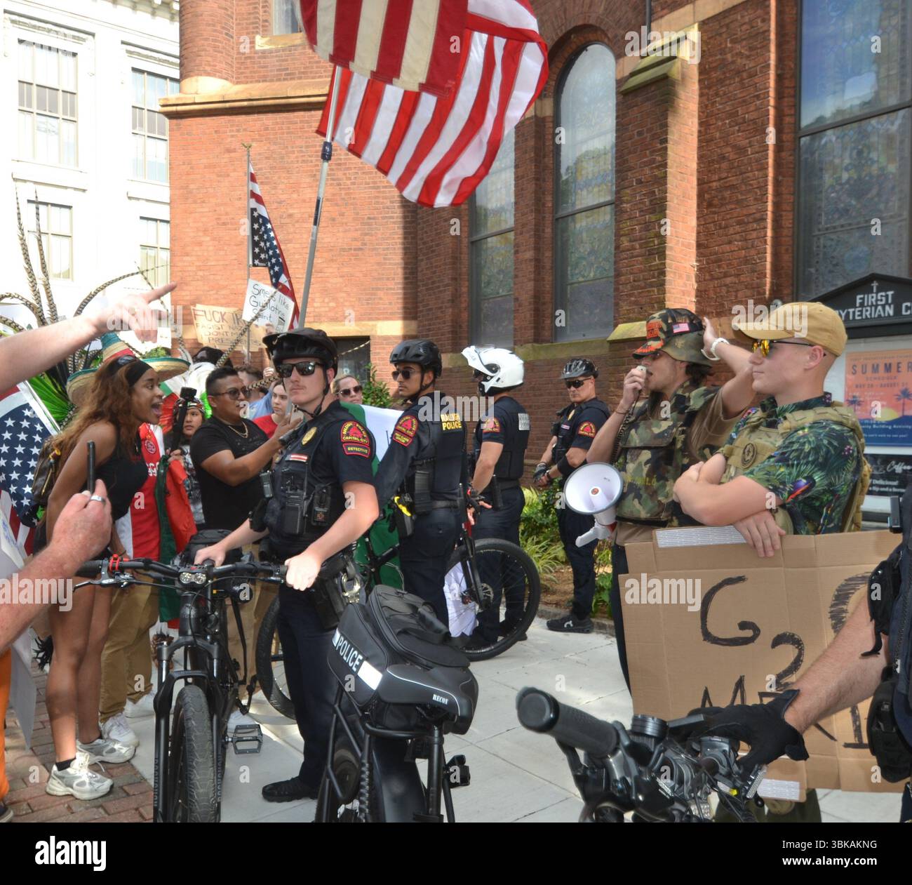 Raleigh Police form a barrier to protect two counter-protesters at the ...