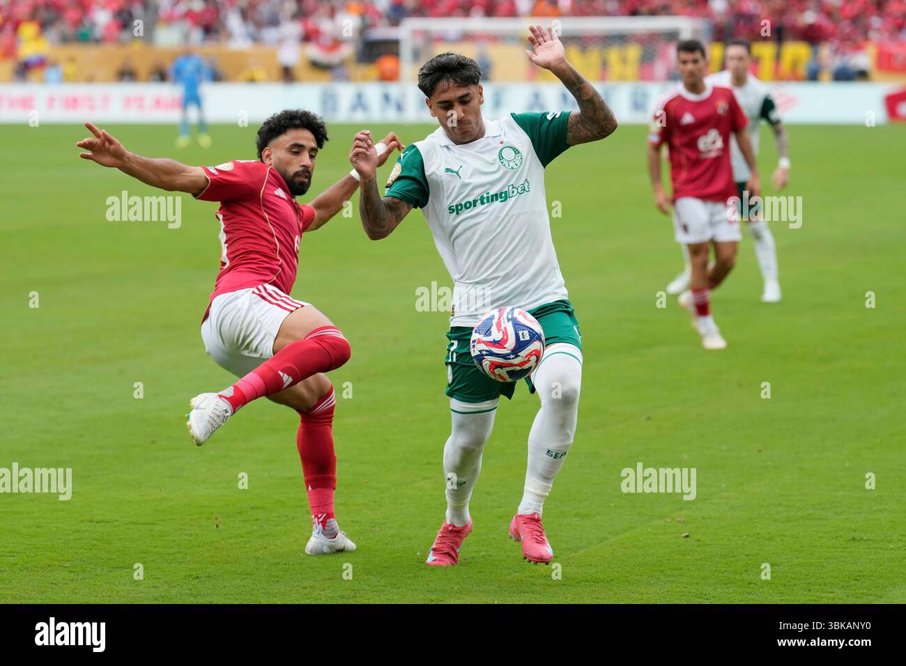 Al Ahly's Achraf Bencharki, left, and Palmeiras' Micael fight for the ...
