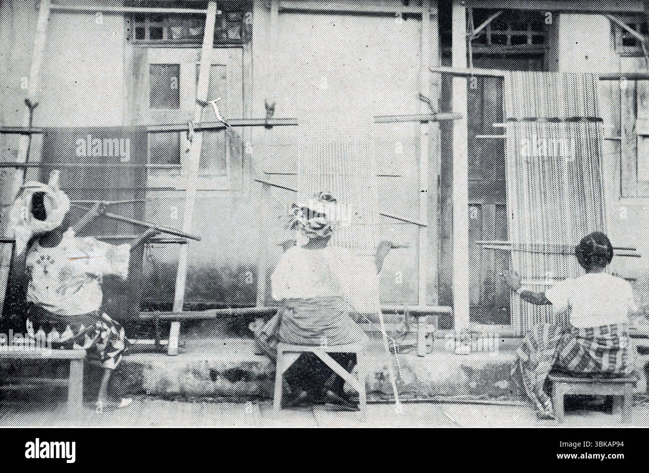 Police wives weaving at Sapele, seated beside large looms. All clothes ...