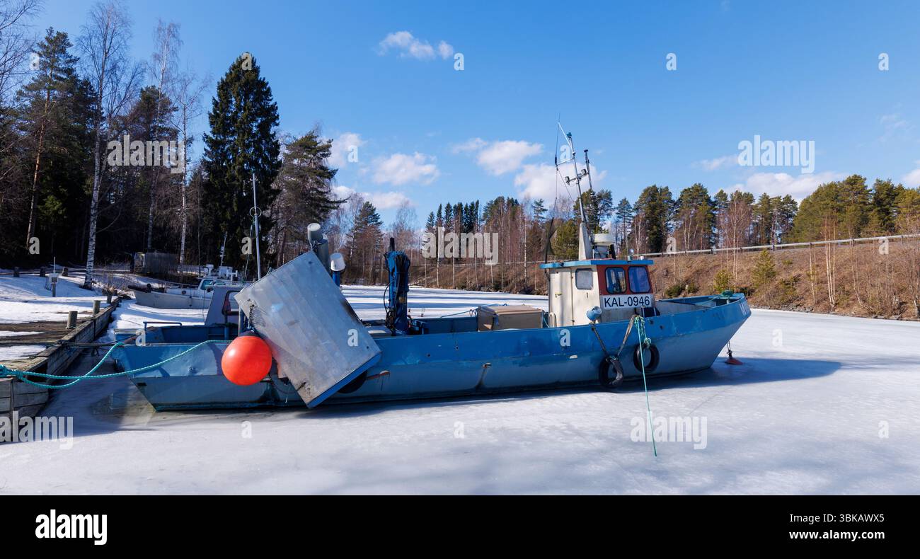 Small inland fishing trawlers anchored and stuck in ice at Spring at ...