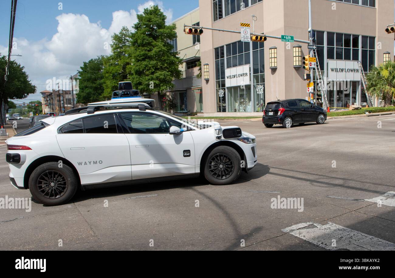 Austin Texas USA, June 19 2025: Waymo-branded robo-taxi, in partnership with Uber, provides ...