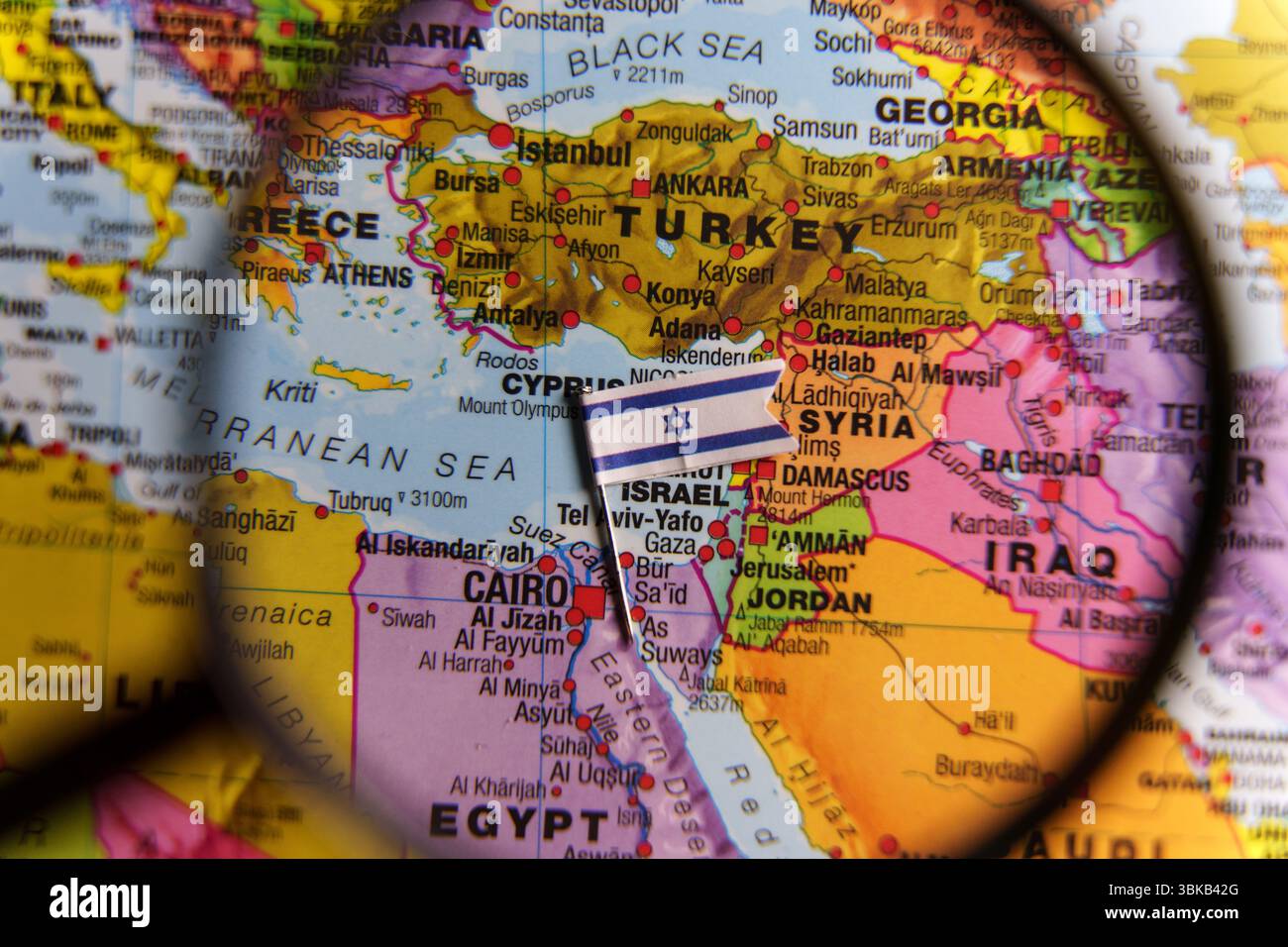 Israel marked with a flag under magnifying glass on Middle East map ...