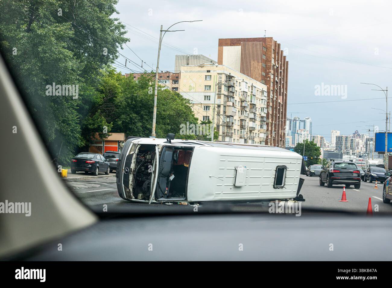 overturned van in the middle of a 4-lane highway in the center of the ...