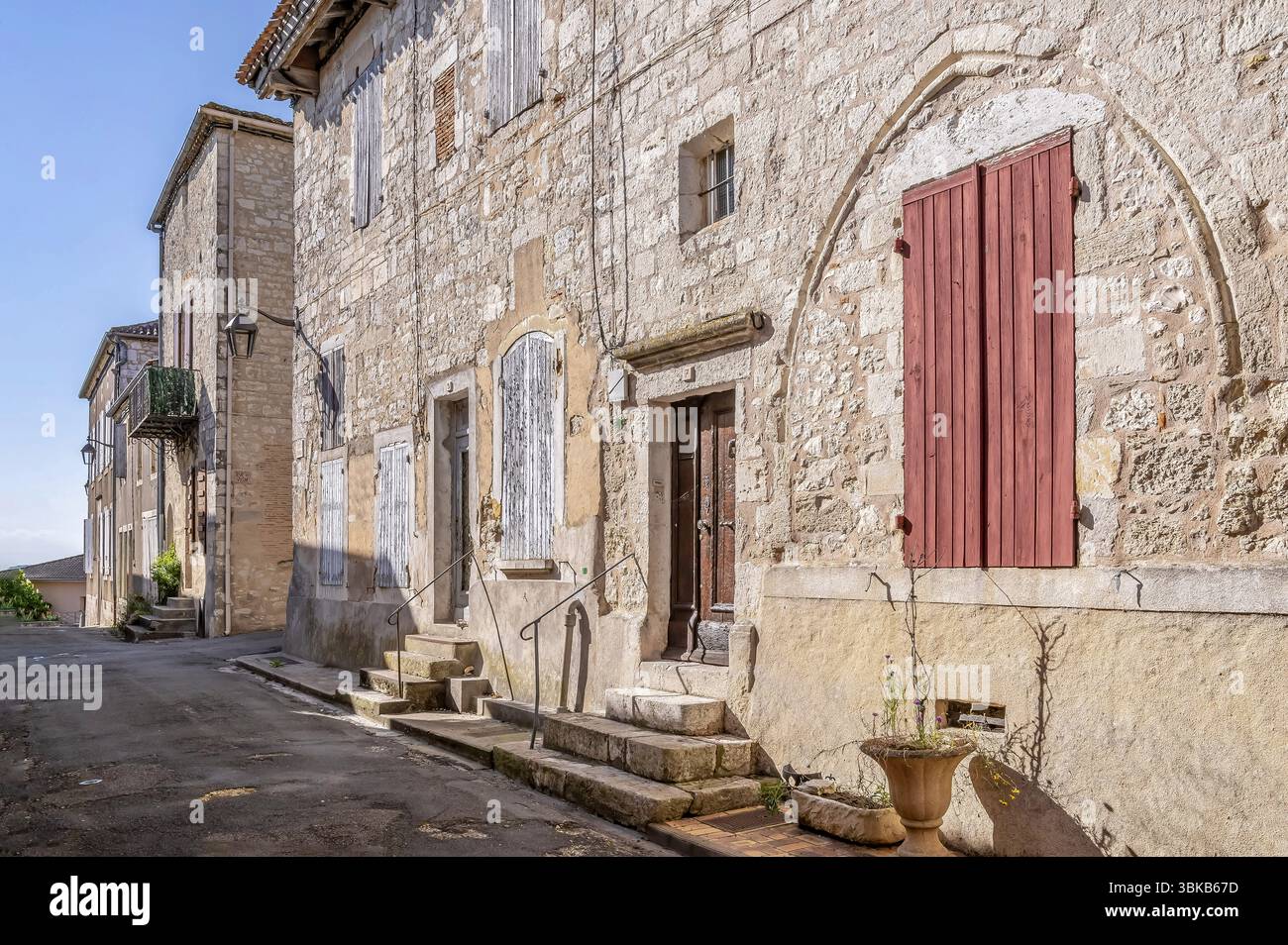 Medieval natural stone facades with reddish-brown and pastel-coloured ...