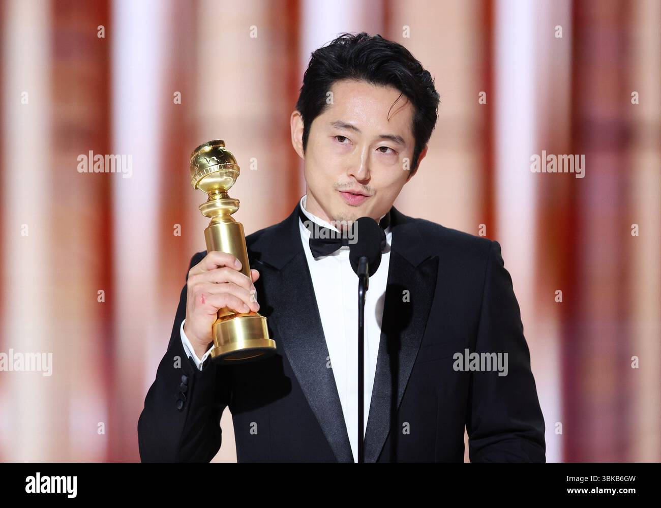 Steven Yeun accepts the award for Best Performance by a Male Actor in a ...