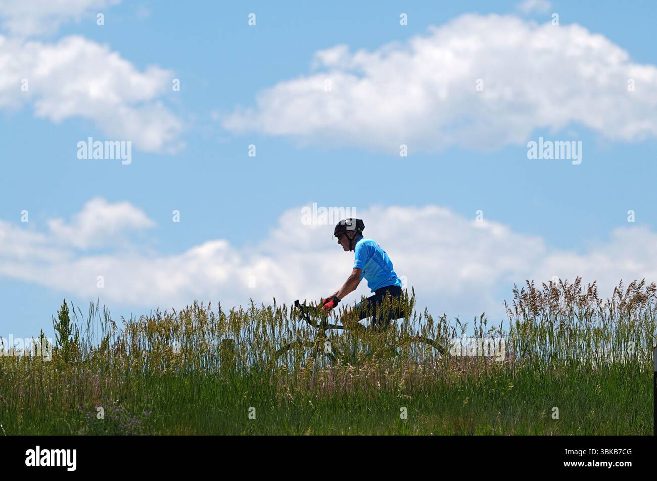 Cyclist moves along path as daytime high temperature soars into the mid ...