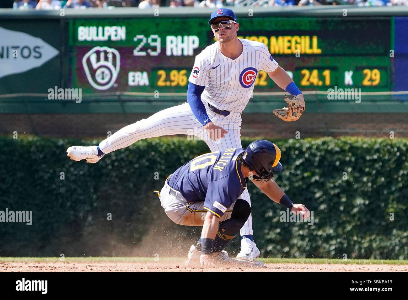 Chicago Cubs second baseman Nico Hoerner, top, forces out Milwaukee ...