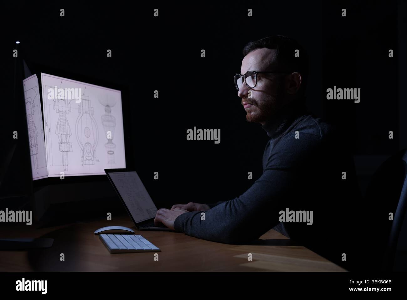Engineer working with digital drawings at table in office Stock Photo ...
