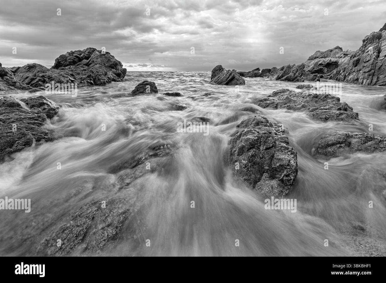 A Wide Angle Closeup Of A Wave Rolling To Shore Flowing Over Sea Rocks ...