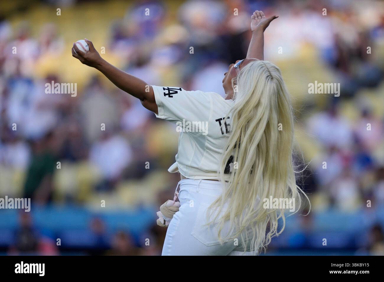 Lizzo reacts as she prepares to the throw the ceremonial first pitch ...