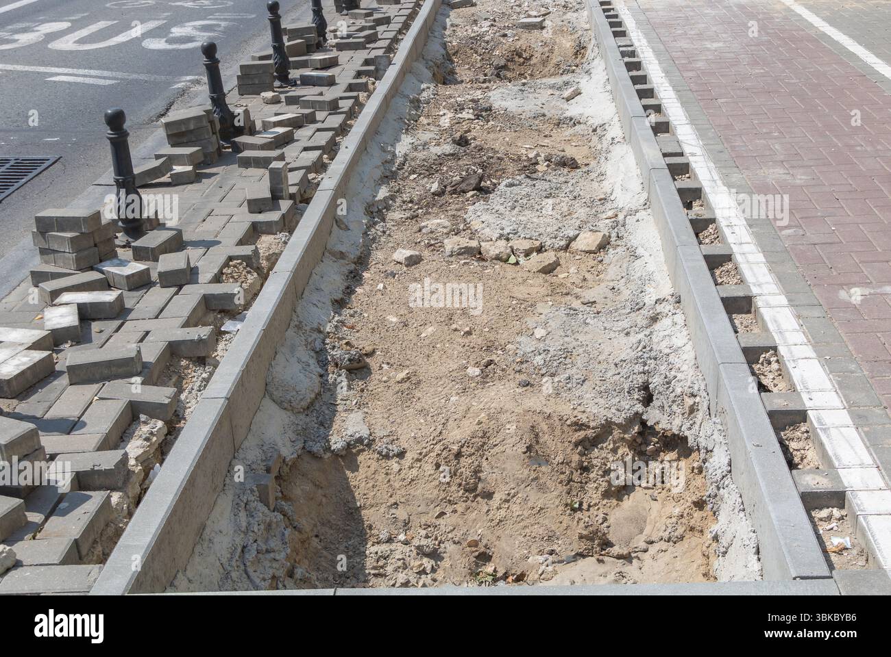 On the street, there is an open trench for road construction and a ...