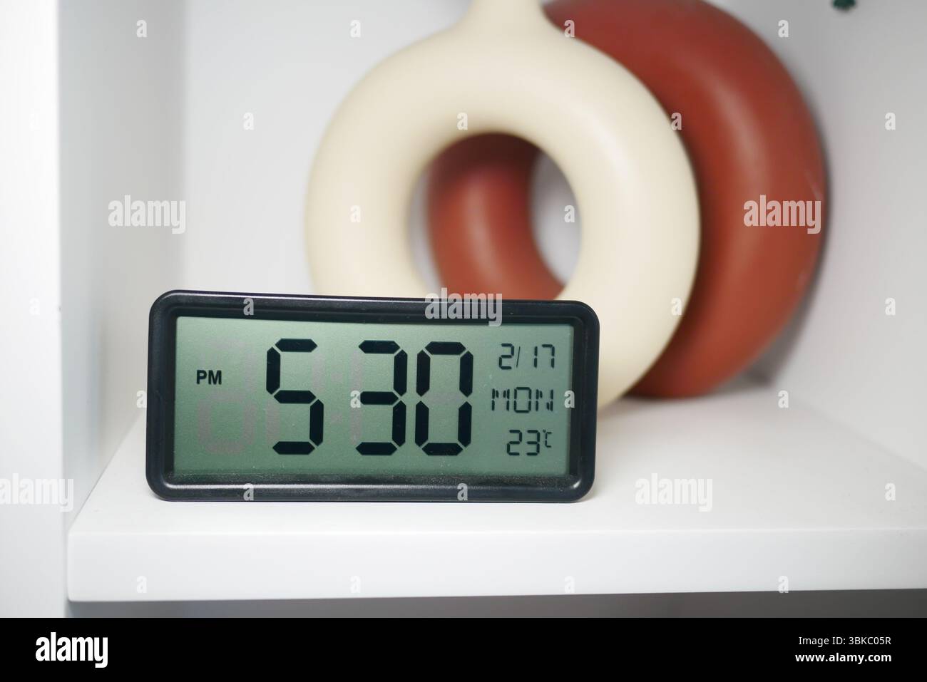 Clock displays time and temperature in a cozy setting Stock Photo - Alamy
