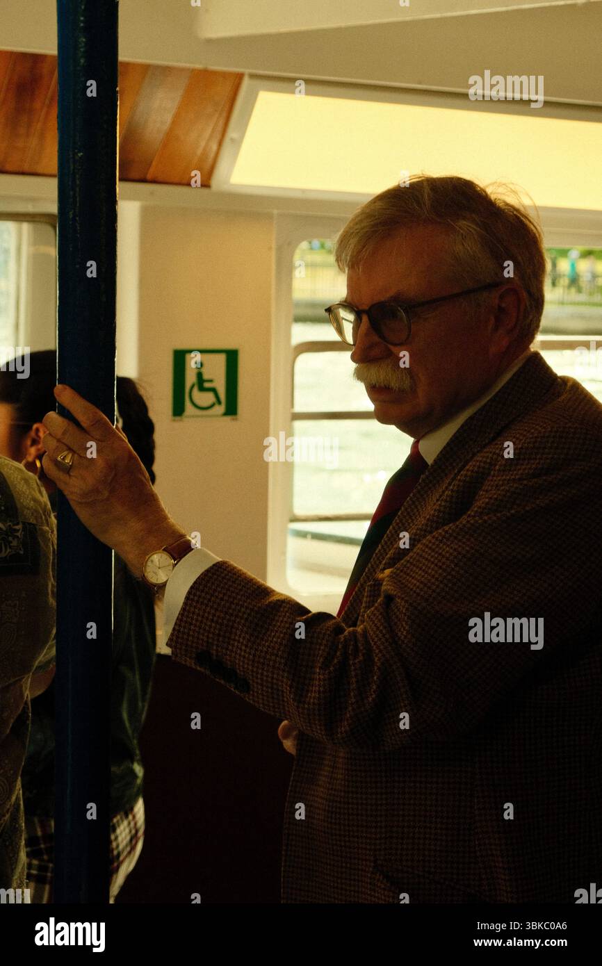 An older rich man with glasses and mustache wearing a classy vintage ...