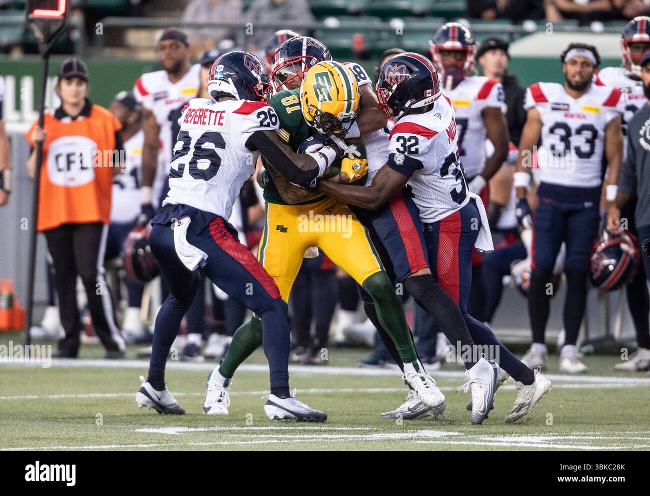 Edmonton Elks' Zach Mathis (81) is surrounded by the Montreal Alouettes ...