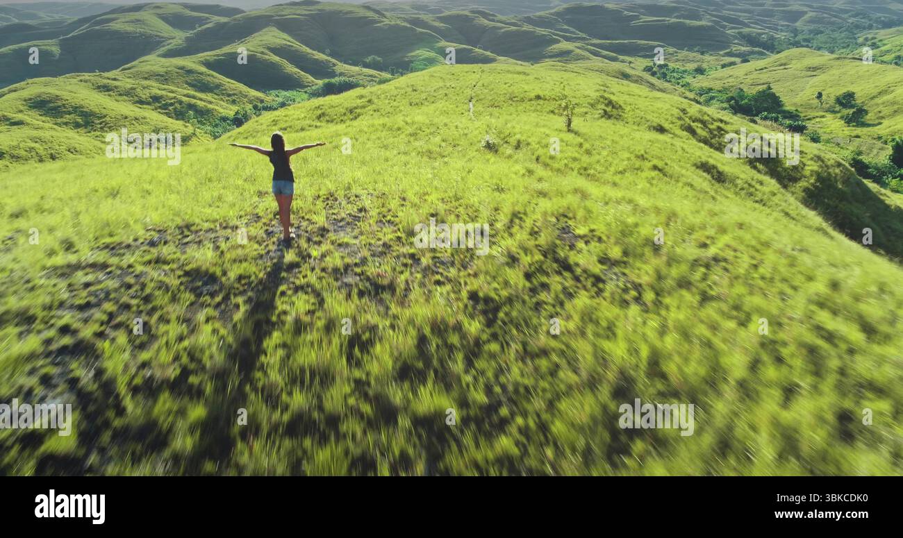 Aerial view of a young female tourist embracing the beauty of nature in ...