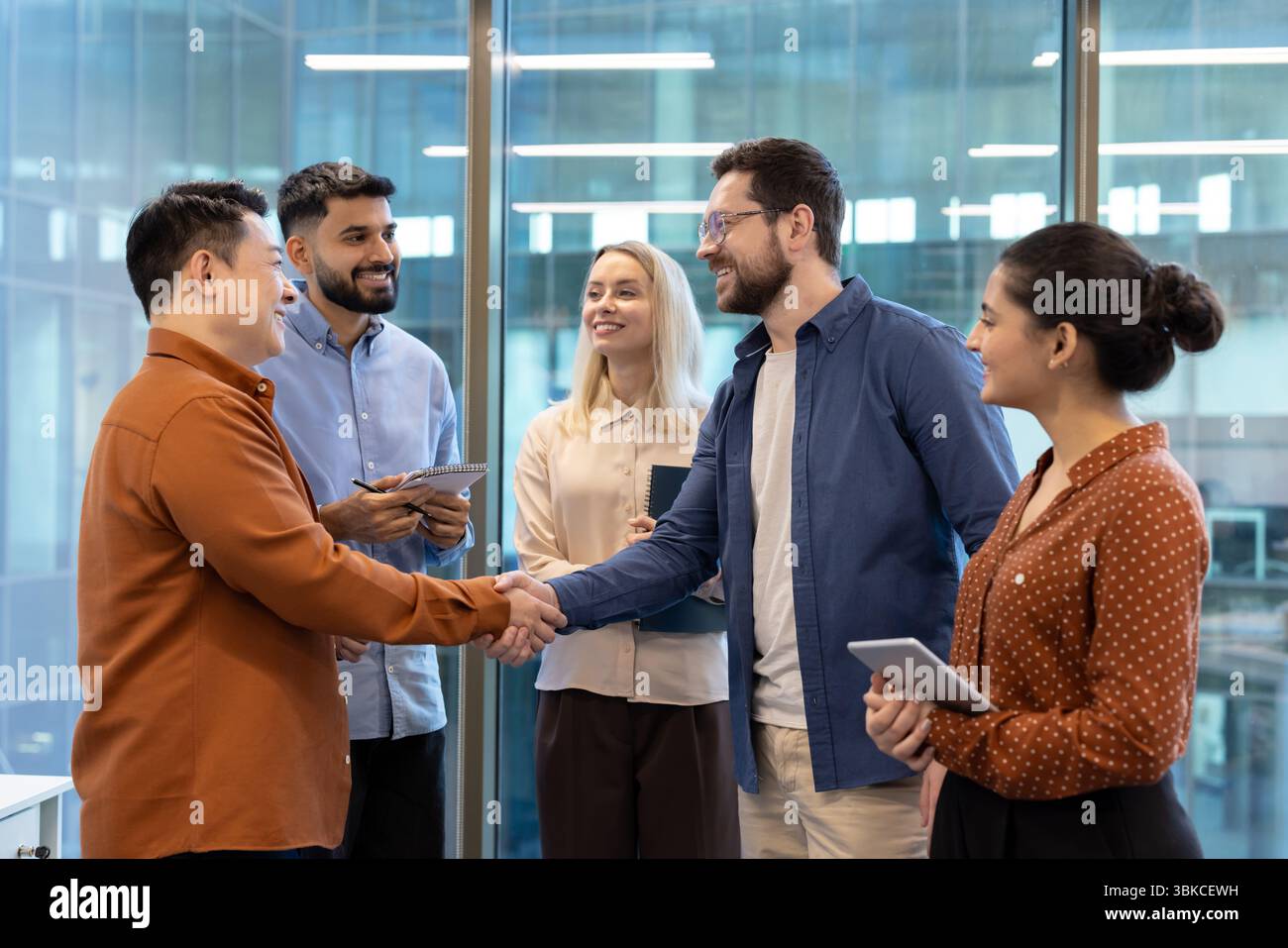 Professional team members shake hi-res stock photography and images - Alamy