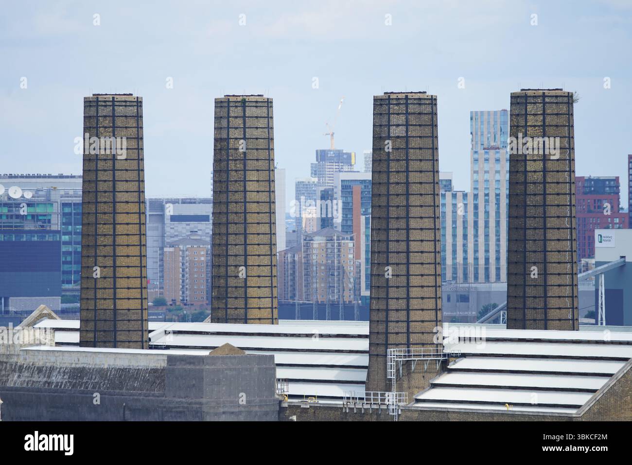 Industrial Chimneys With City Skyline in the Background and Urban ...