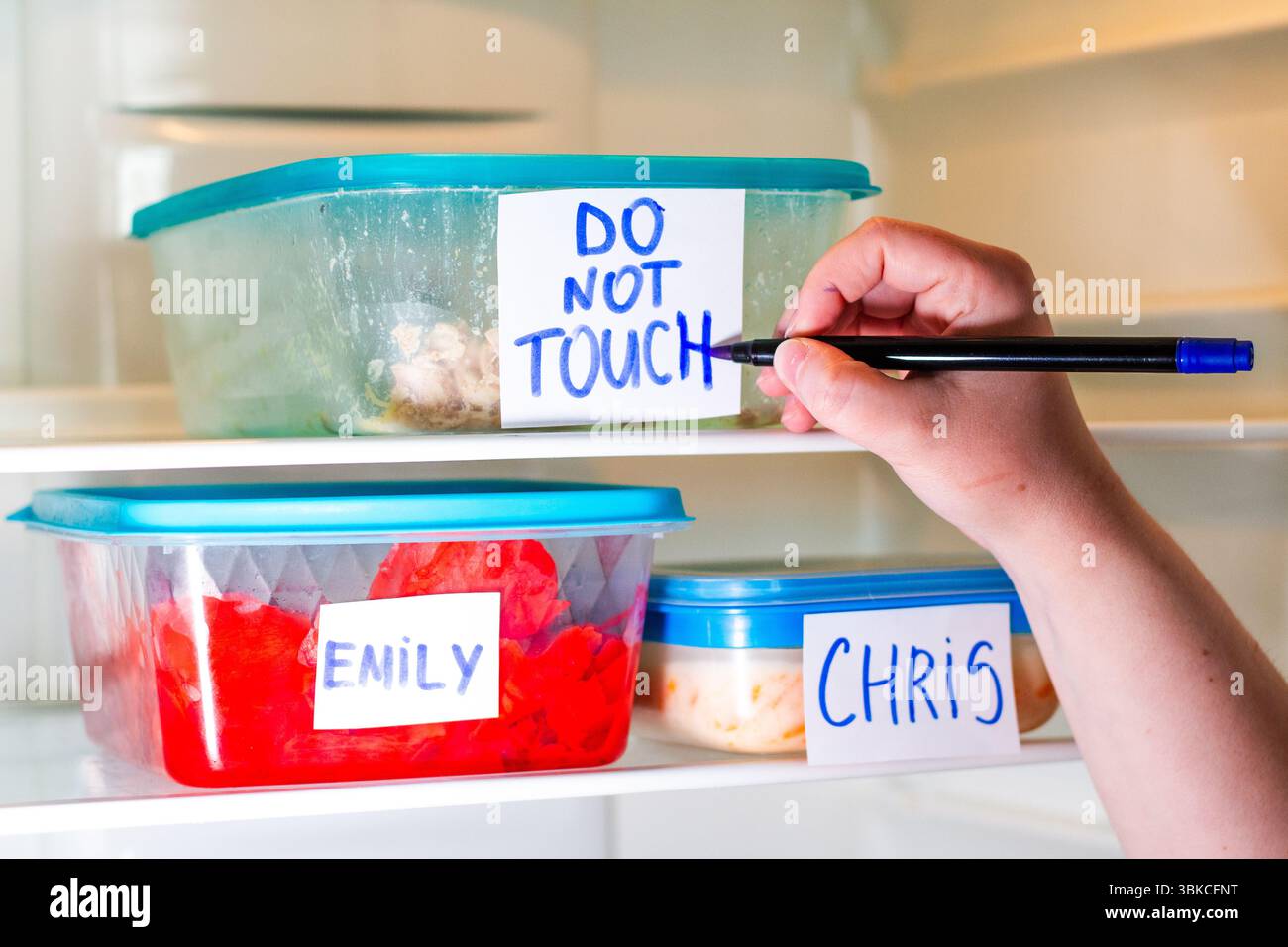 Office fridge with angry Do Not Touch My Food sticker on meal ...