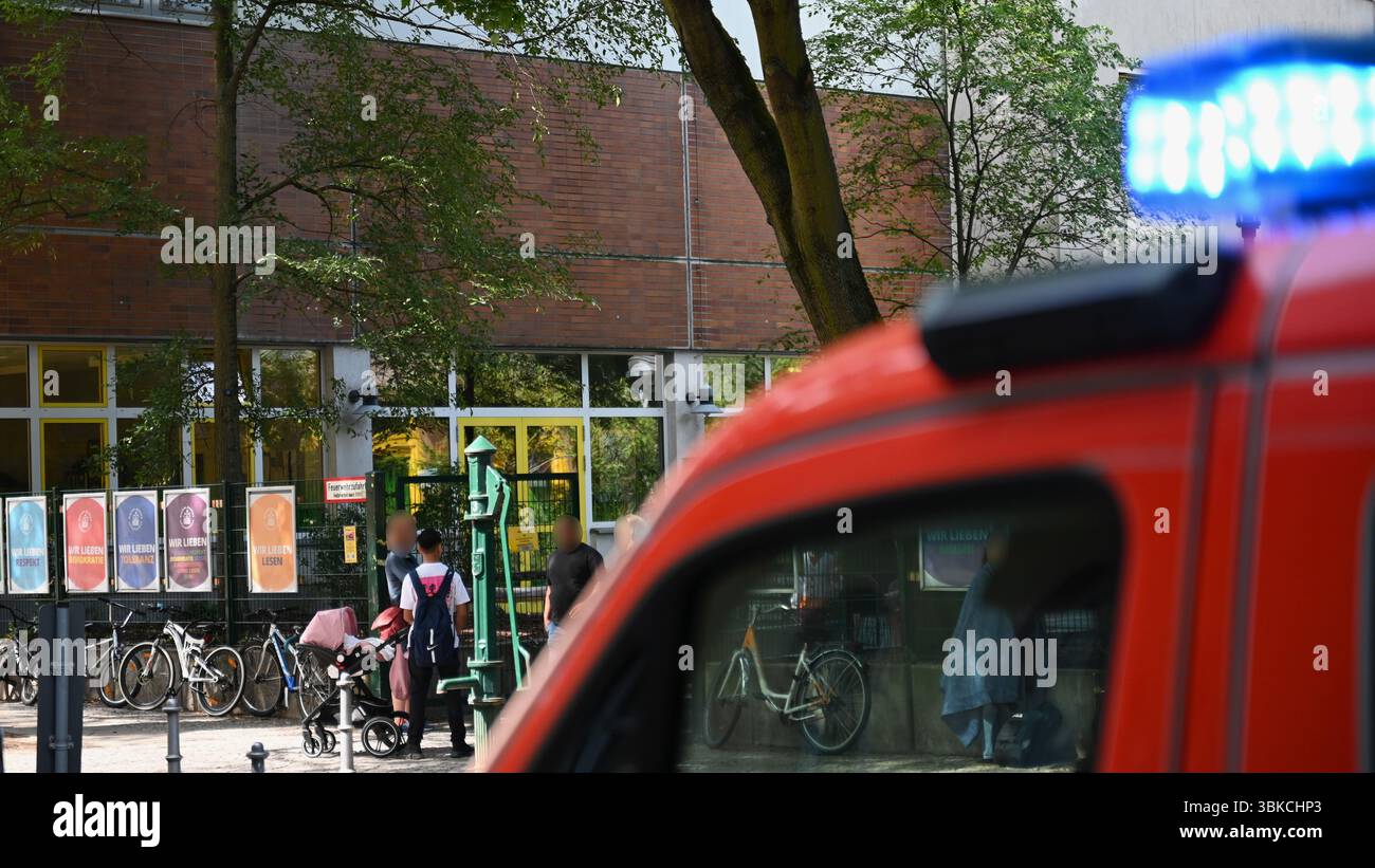 20 June 2025, Berlin: Fire department emergency vehicles stand in front ...