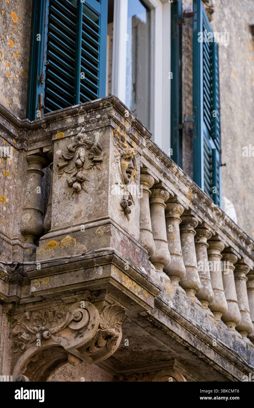 Detailed view of an old stone balcony with sculptures and columns in a ...