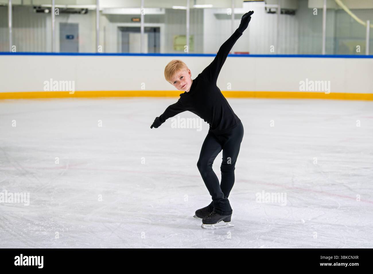 boy figure skater skates on an indoor rink, demonstrating skill Stock ...