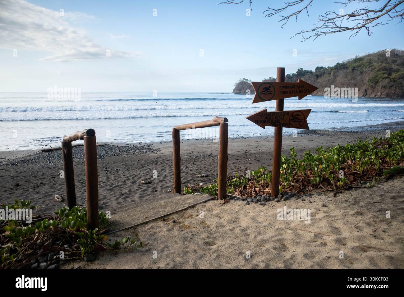 Beach access path with swimming safety signs and ocean view Stock Photo ...